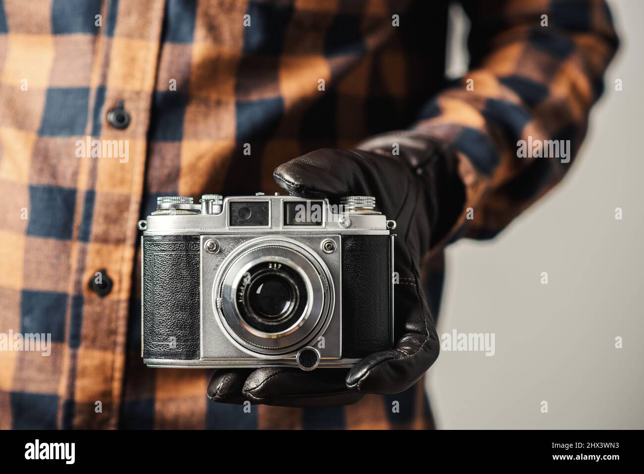 Old film camera in man's hand. Photography and hobby concept Stock ...