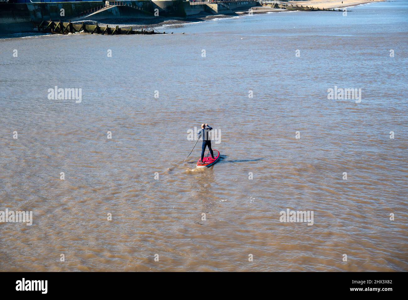 Man on paddle board in the North sea at Cromer norfolk Stock Photo - Alamy