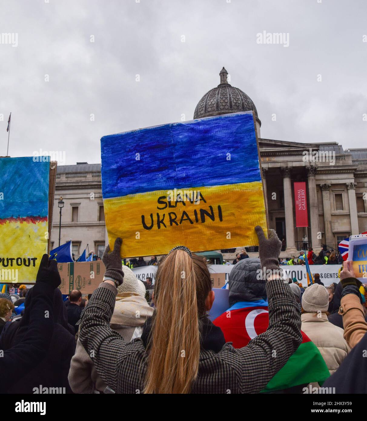 London, UK. 5th March 2022. A woman holds a 'Slava Ukraini' ('Glory to ...