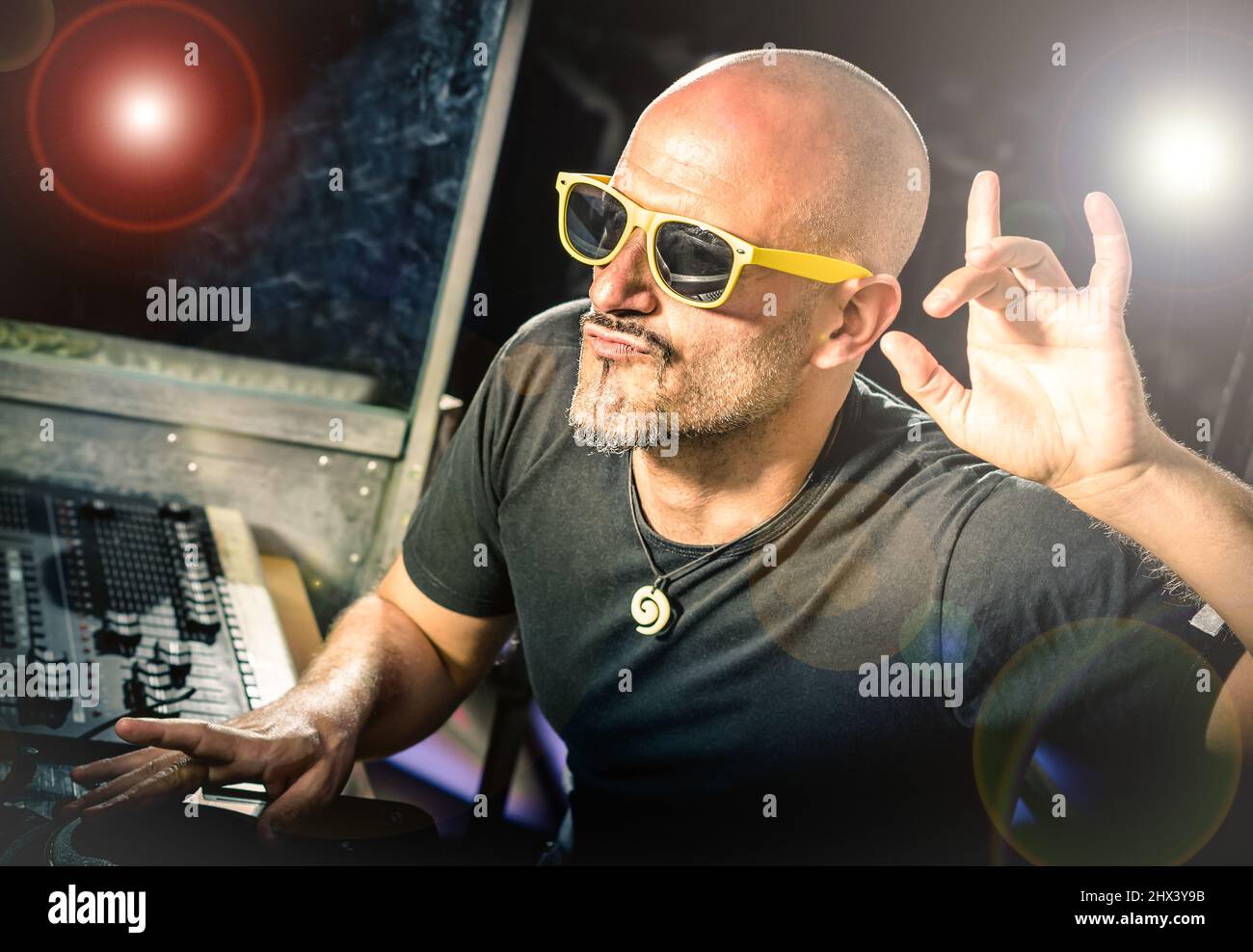 Deejay performing house electro music at underground disco party night ...