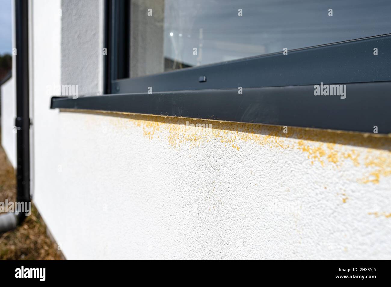 Yellow mounting foam filled under the window sill, white plaster is ...