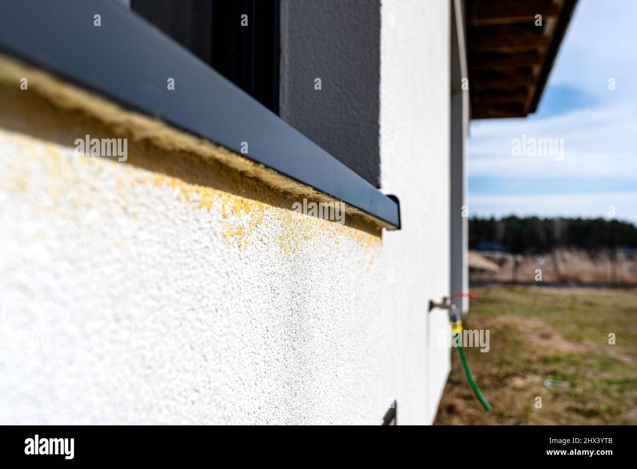 Yellow mounting foam filled under the window sill, white plaster is ...