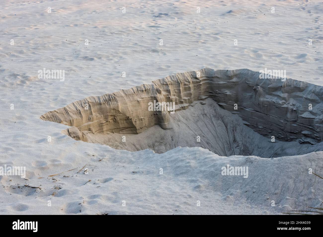 Dry sand land with a big dug hole close up Stock Photo - Alamy