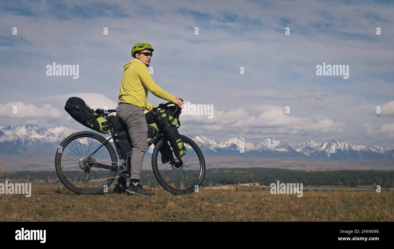 The man travel on mixed terrain cycle touring with bikepacking. The ...