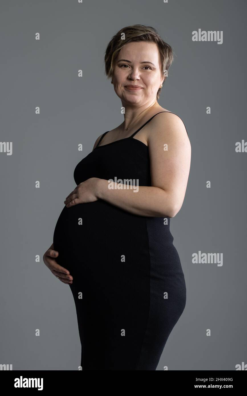 Portrait of pregnant woman on her third trimester, two weeks before ...