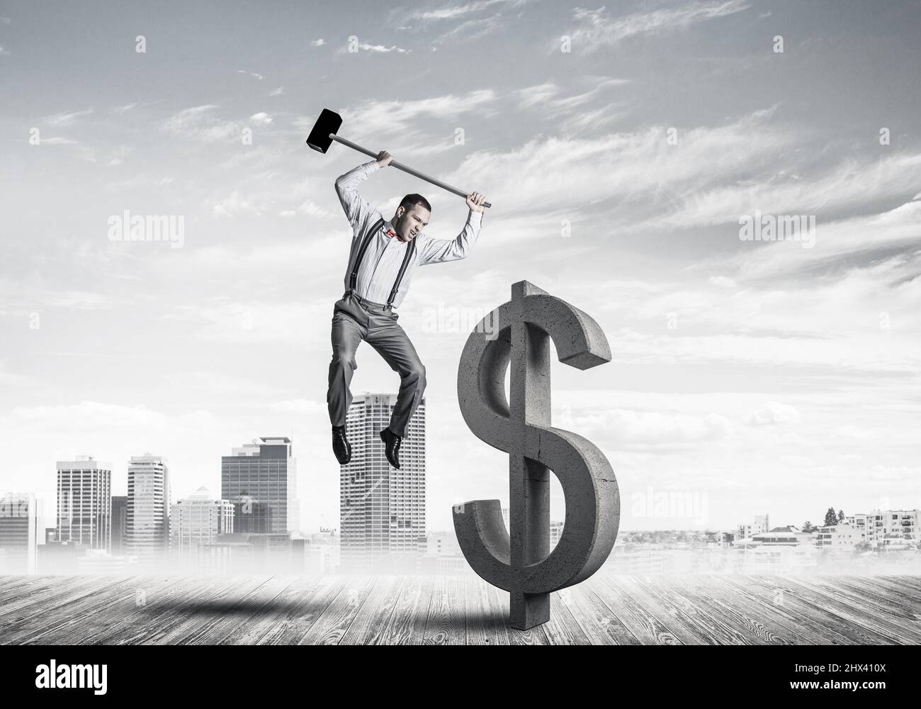 Determined banker man against modern cityscape breaking dollar concrete ...
