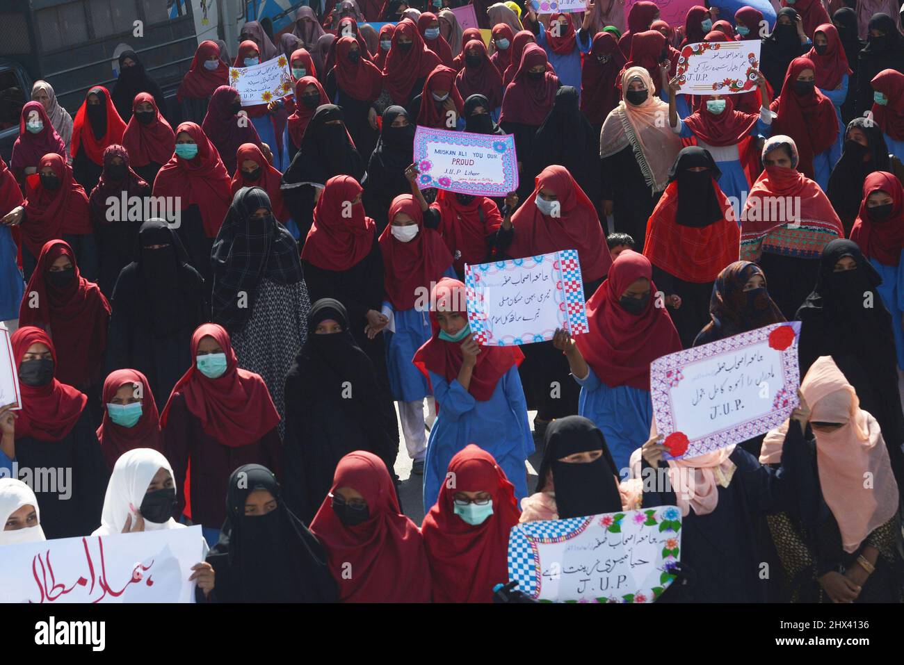 Pakistani Aurat March activists hold placards and shout slogans as they ...