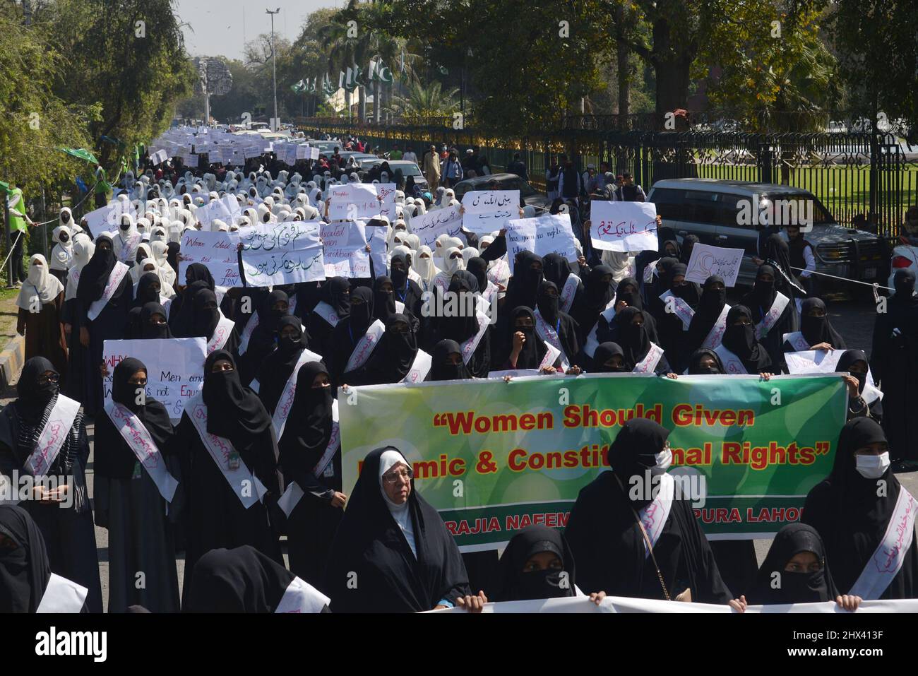 Pakistani Aurat March activists hold placards and shout slogans as they ...