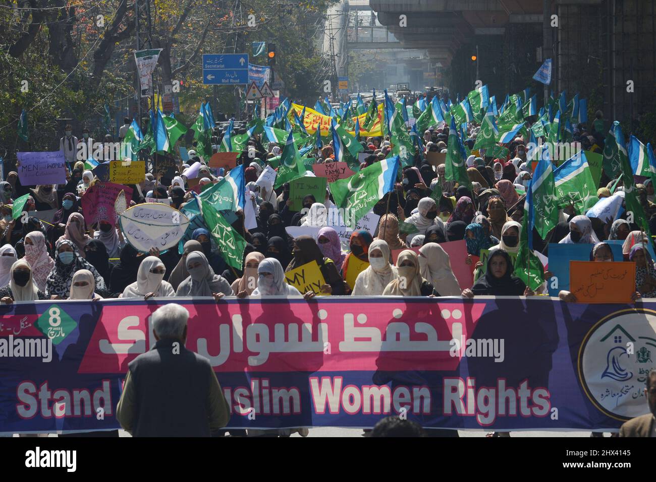Pakistani Aurat March activists hold placards and shout slogans as they ...