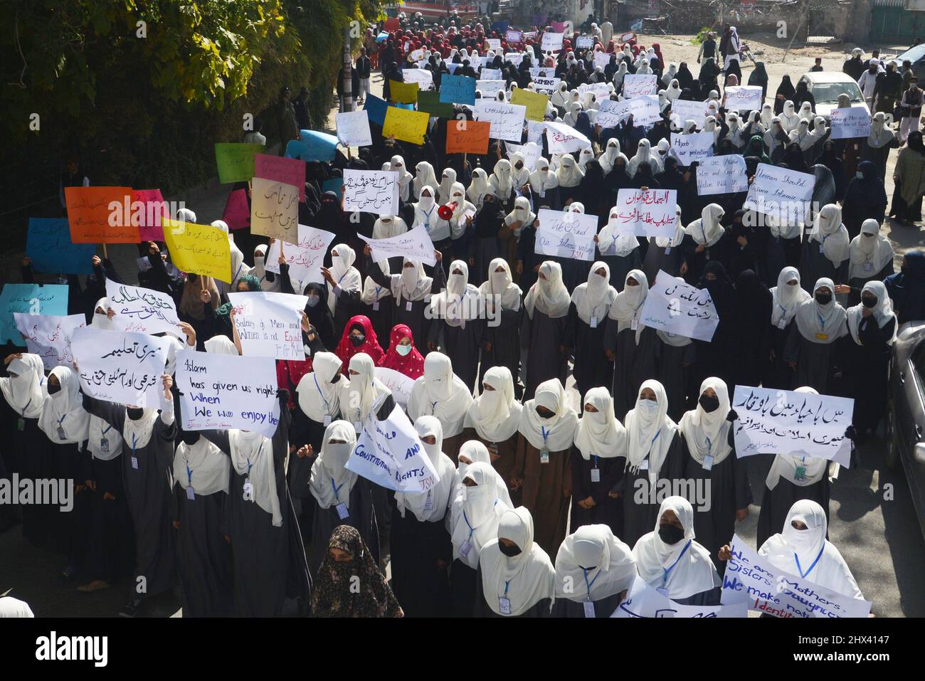 Pakistani Aurat March activists hold placards and shout slogans as they ...