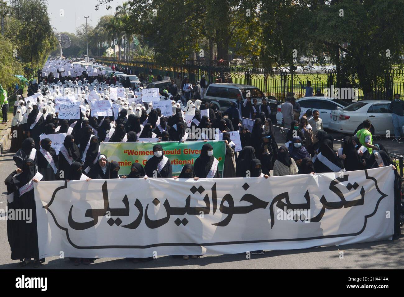 Pakistani Aurat March activists hold placards and shout slogans as they ...