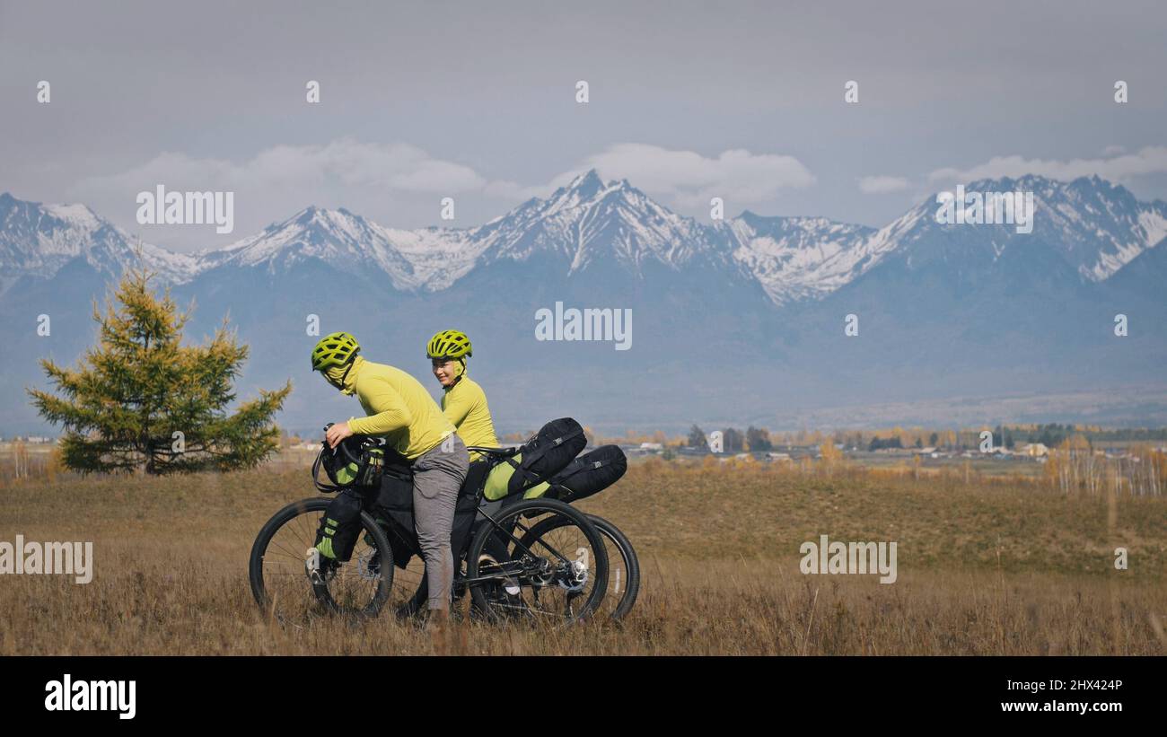 The man and woman travel on mixed terrain cycle touring with ...