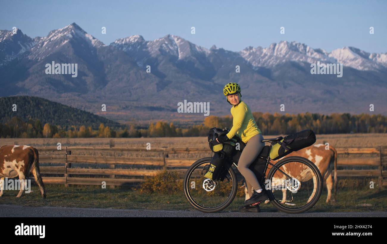 The woman travel on mixed terrain cycle touring with bikepacking. The ...