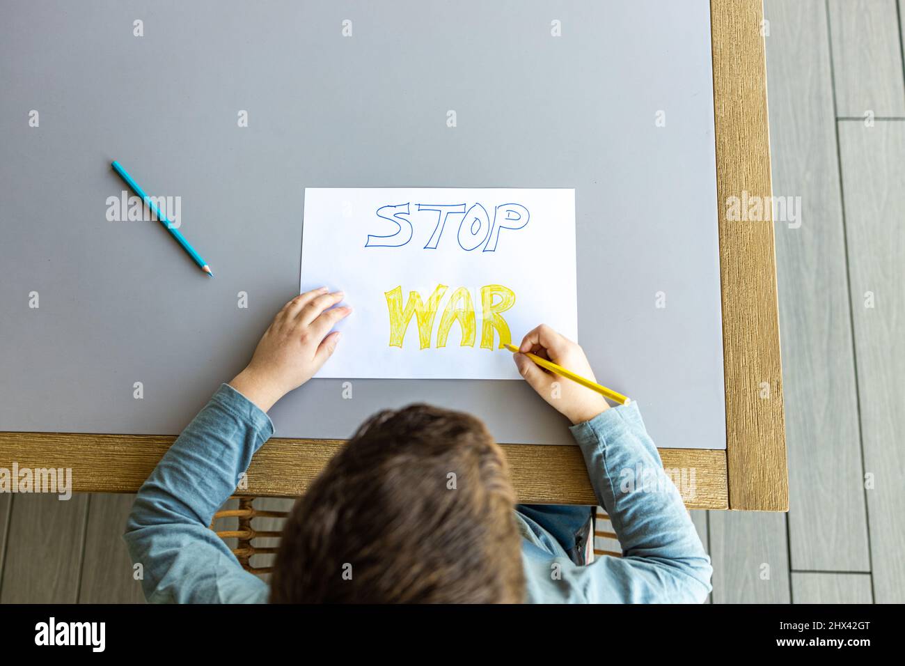 Little kid drawing Stop War on a paper. Ukraine Russia war concept ...