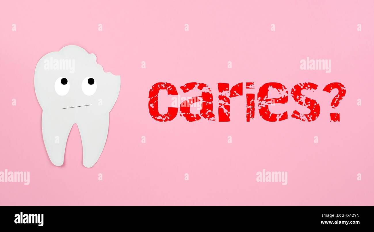 The concept of dental care, caries, copy space. White tooth looks at ...