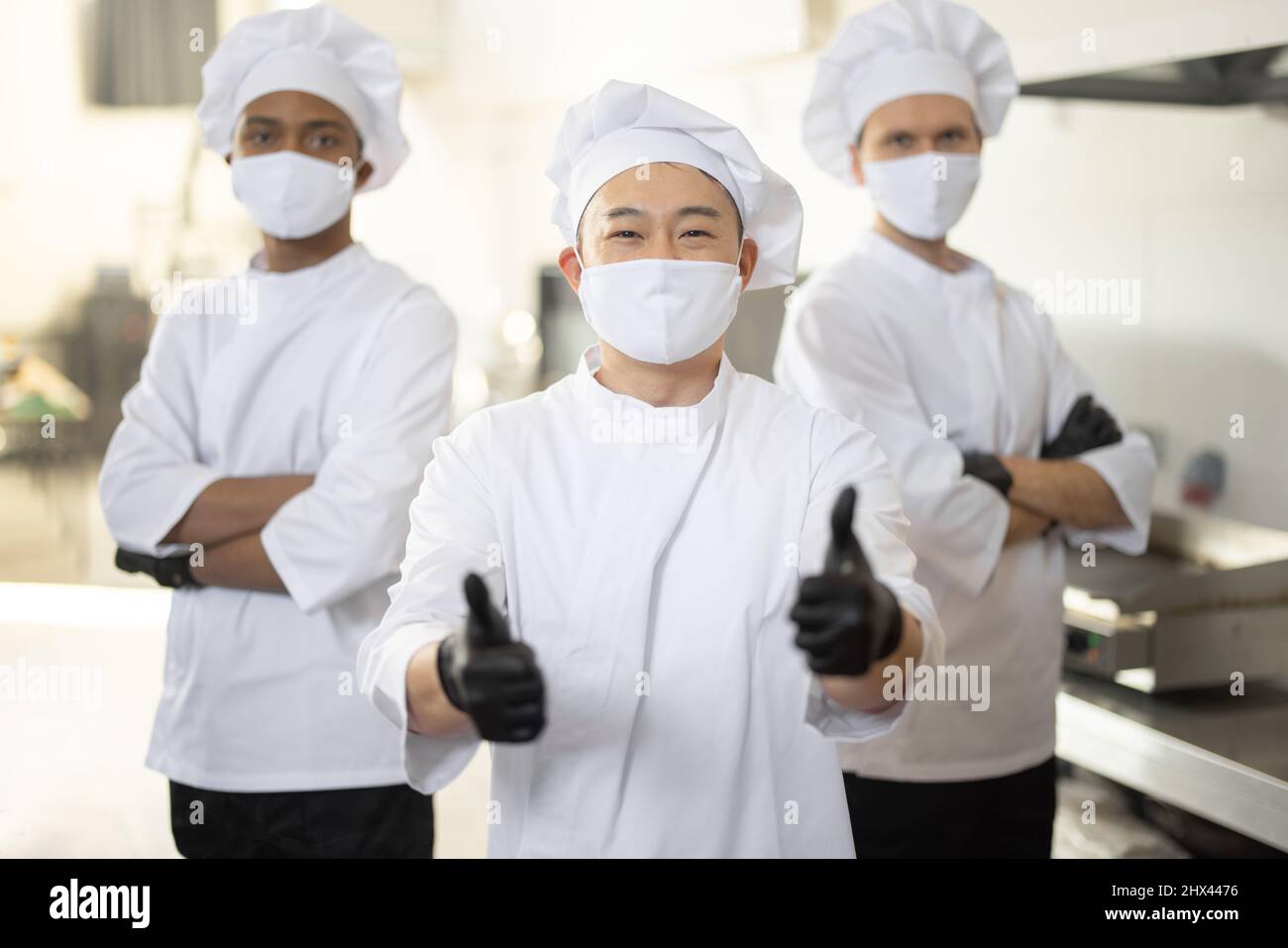Portrait of three well-dressed chef cooks with different ethnicities ...