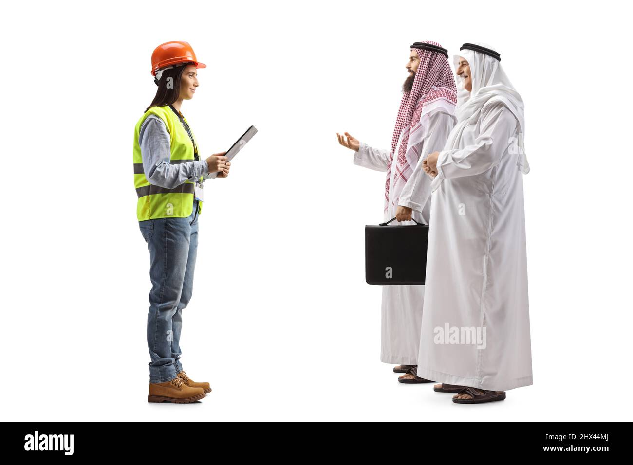 Full length profile shot of arab men talking to a young female engineer ...