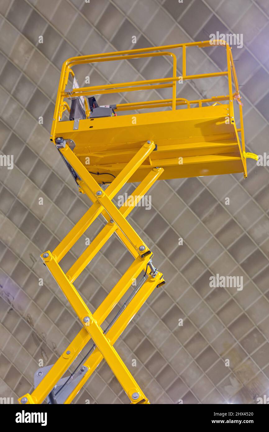 Scissor Lift Aerial Work Platform in Large Hall Stock Photo - Alamy