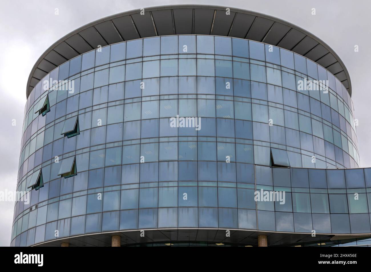 Modern Round Office Building With Blue Glass Facade Stock Photo - Alamy