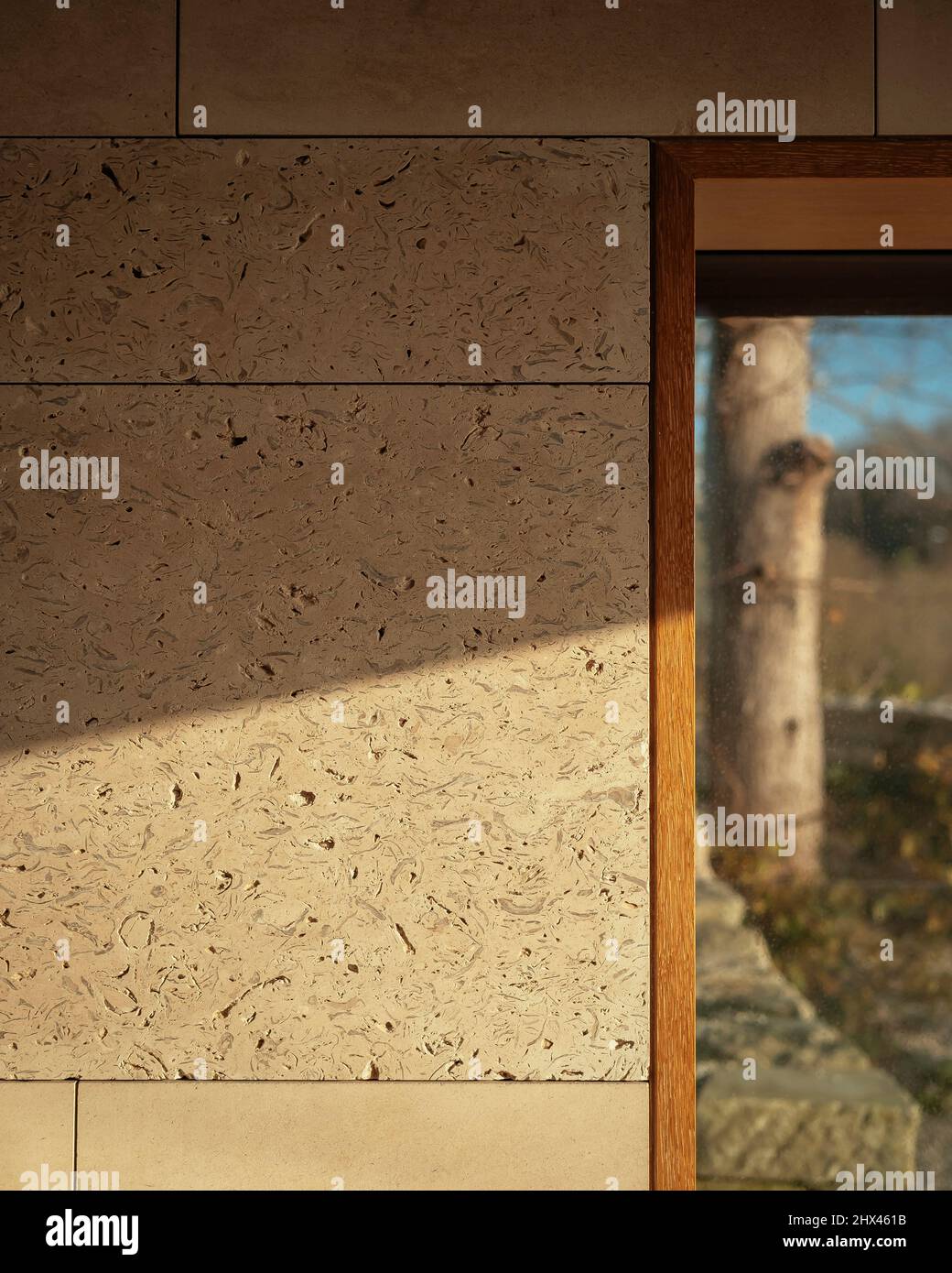 Interior detail of warm wooden window lintel and the surrounding stone ...