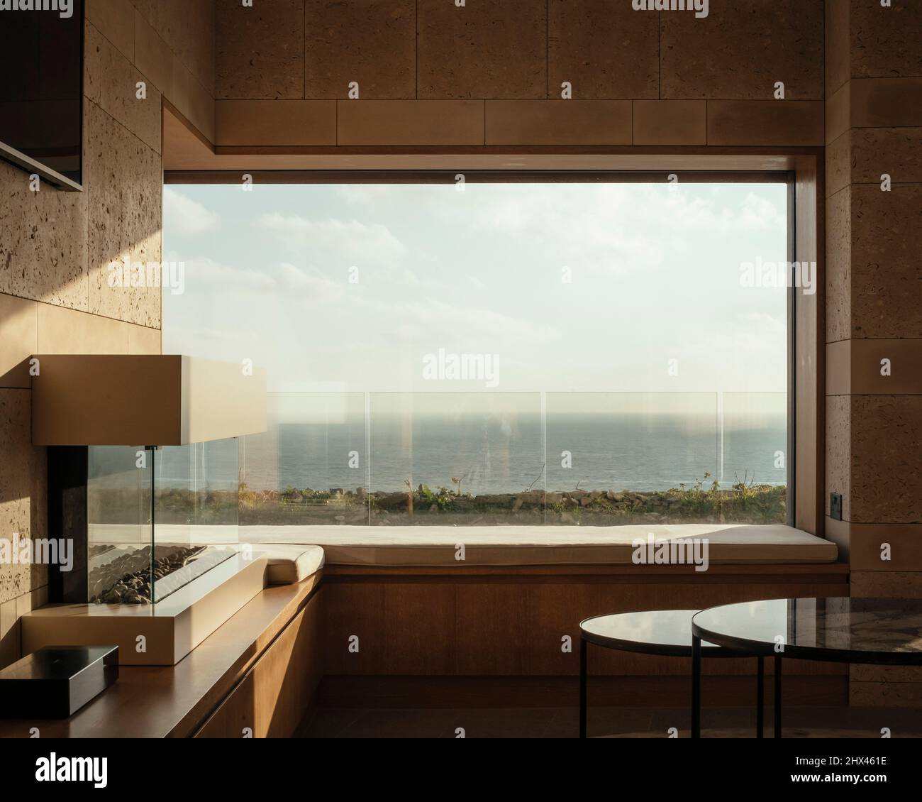 Interior view looking out of large corner window, with window seat ...