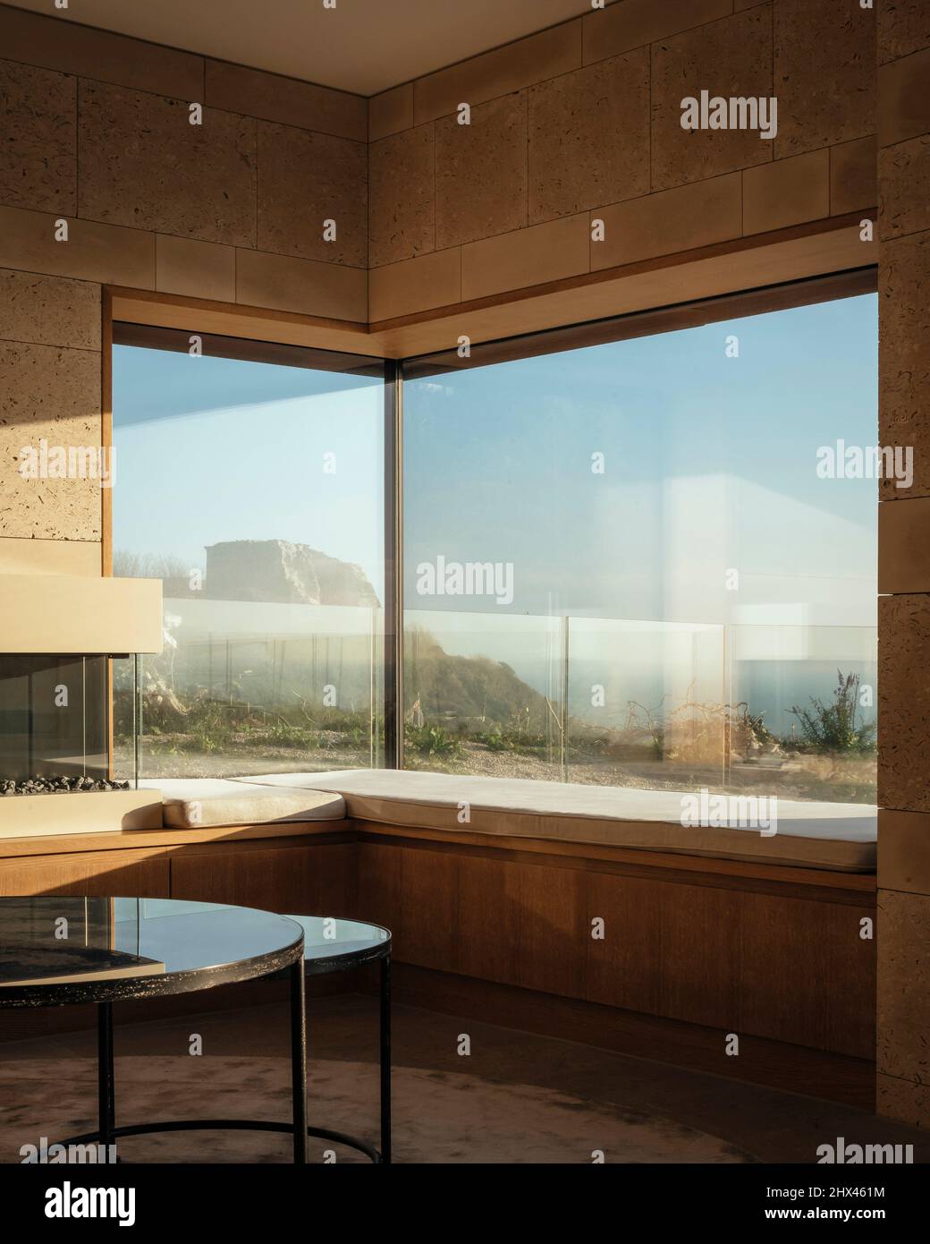 Interior view looking out of large corner window, with window seat ...