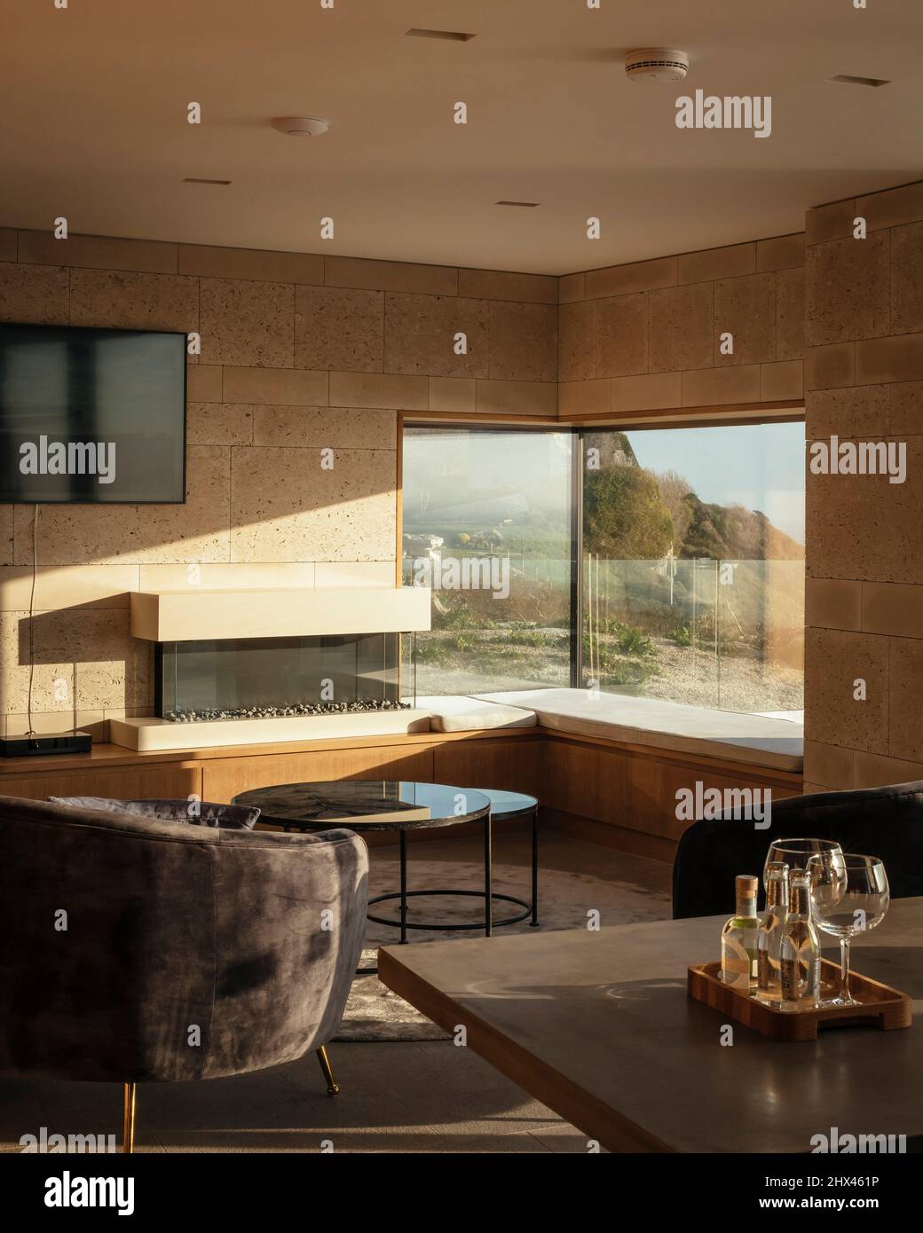 Interior room view looking with large corner window, with window seat ...