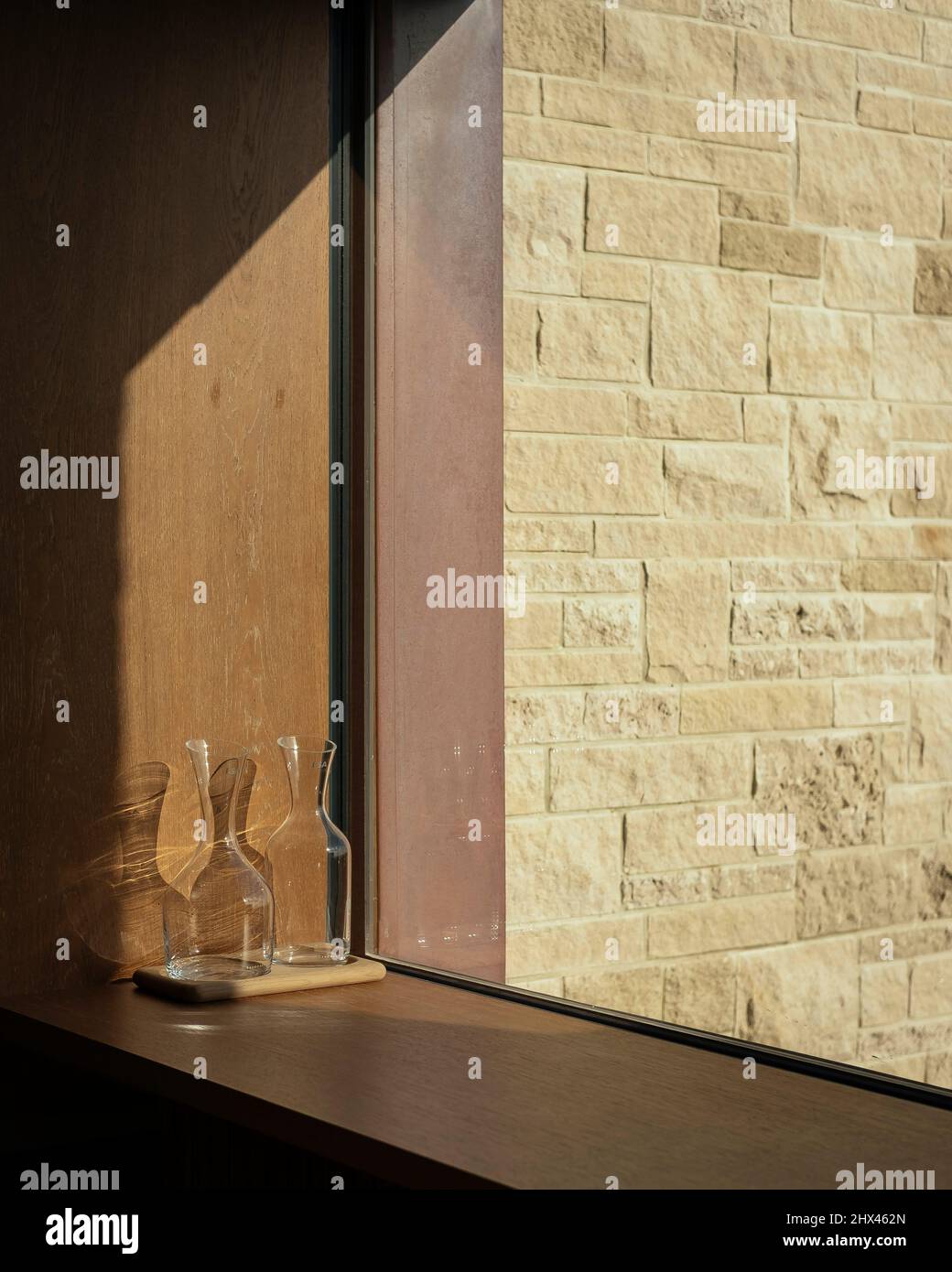 Interior detail of recessed window with wood panelling and exterior ...