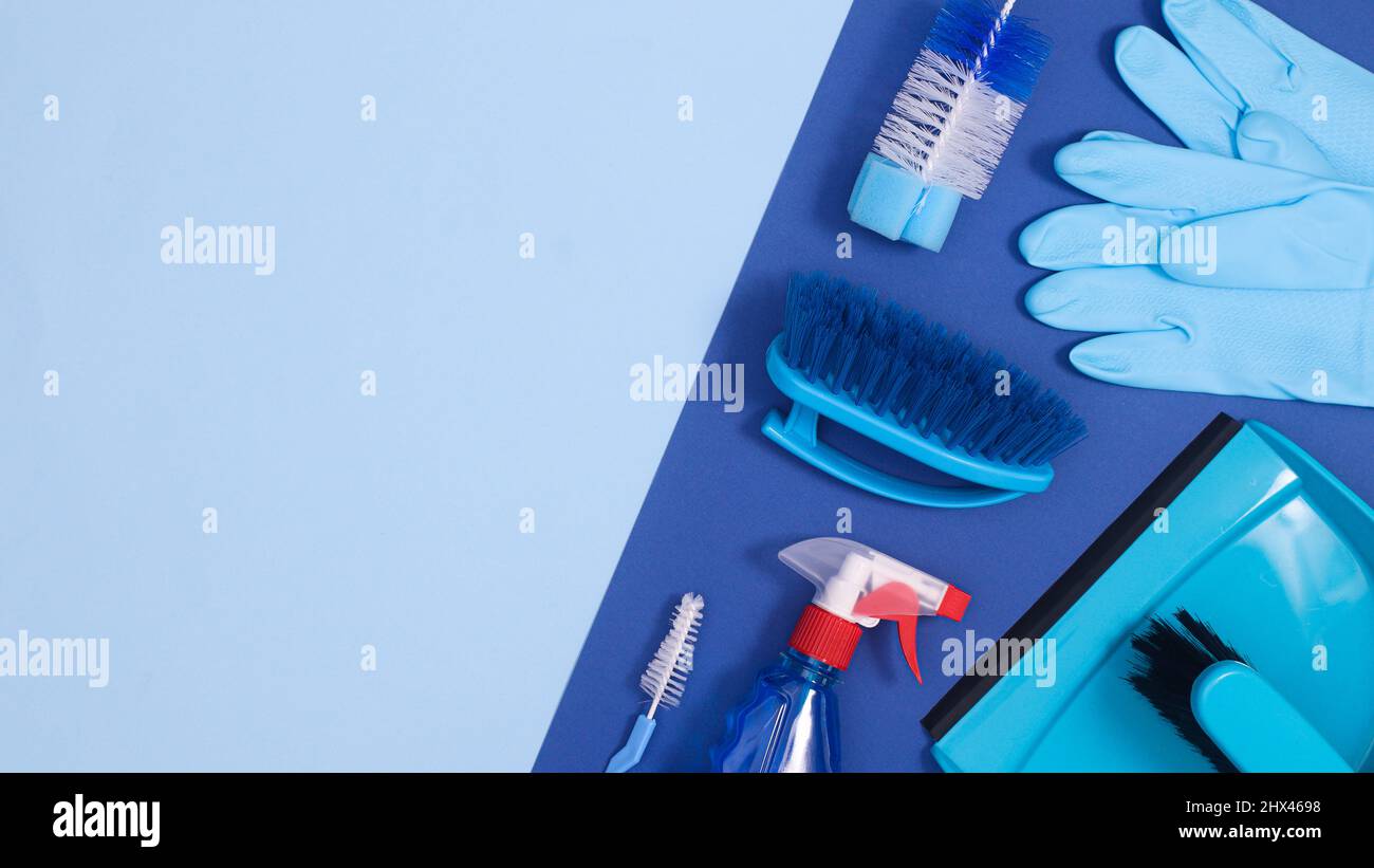 Cleaning tools on deep and pastel blue background with copy space. Flat ...