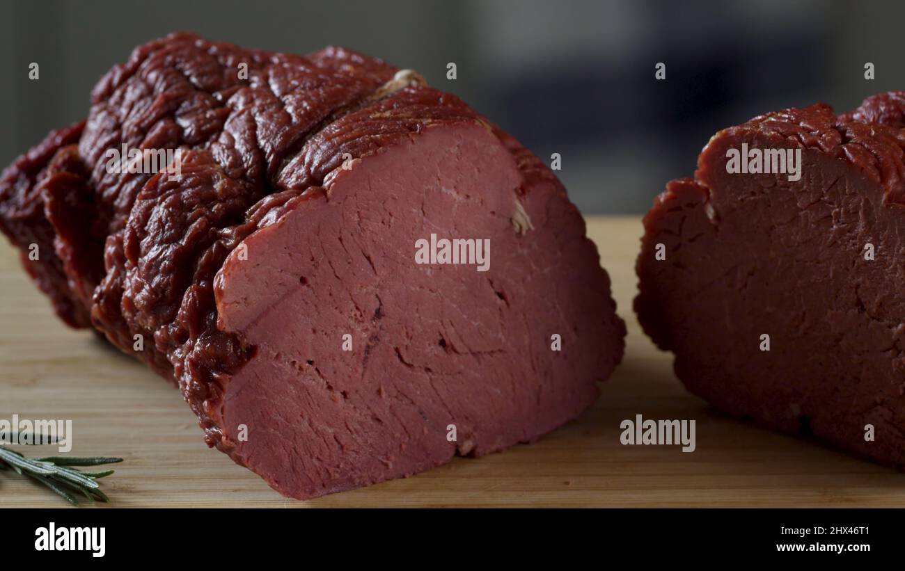 Raw beef steak cut on a wooden board. Piece of ham on a wooden board ...