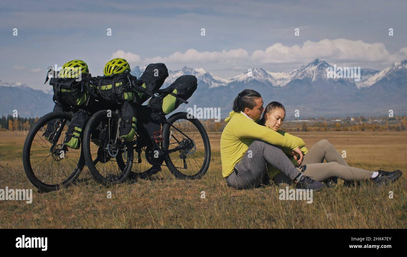 The man and woman travel on mixed terrain cycle touring with ...
