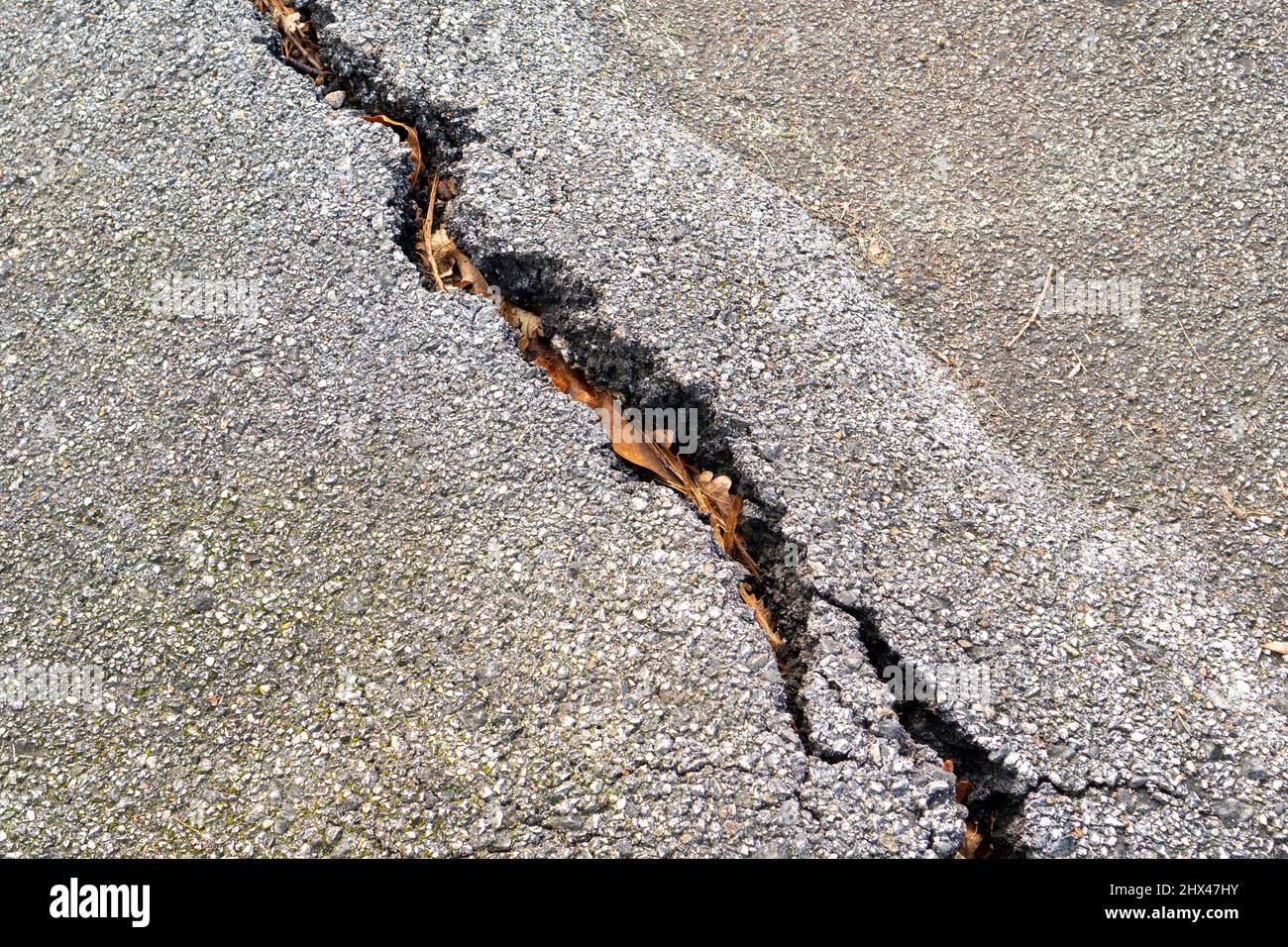 Crack in the asphalt road close-up. Break of the pavement surface Stock ...