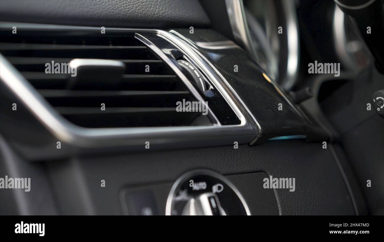 Luxury car interior details. Speedometer and steering wheel. Air heater ...