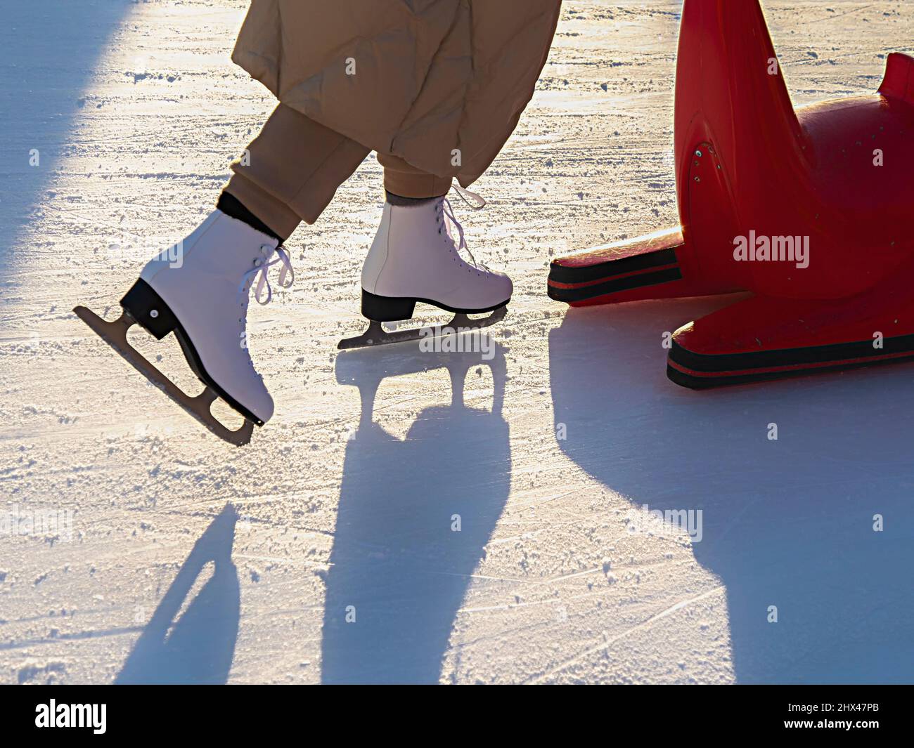 A Girl On The Rink With An Ice Skating Support For Learning Skating A Girl Holds An Aid Or A