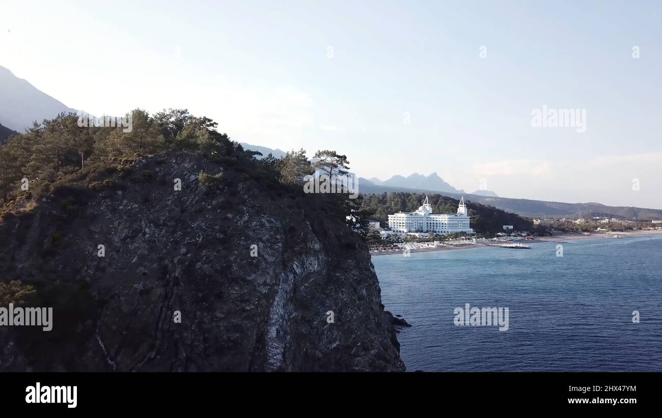 Aerial view on seashore with luxury Hotel with forest and mountains ...