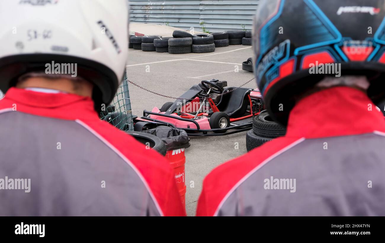 Close up of racer backs wearing special uniforms and helmets going to ...