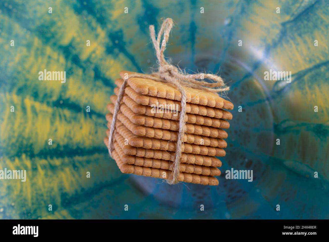 butter biscuits and tied with a jute rope bow as a present, levitating ...