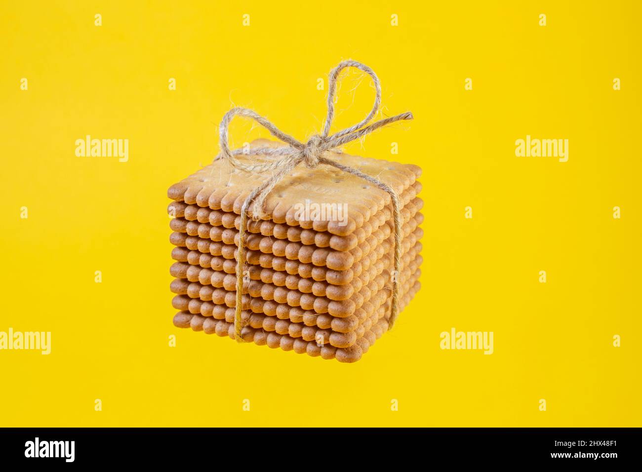 rectangle butter biscuits stacked and tied with jute rope, levitating ...