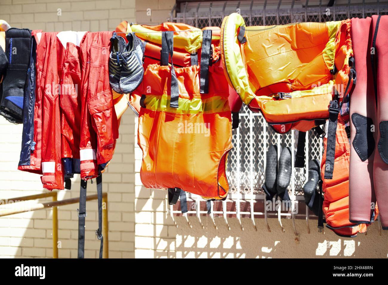 Getting dry in the sunlight. Cropped shot of lifeguard gear hanging on ...