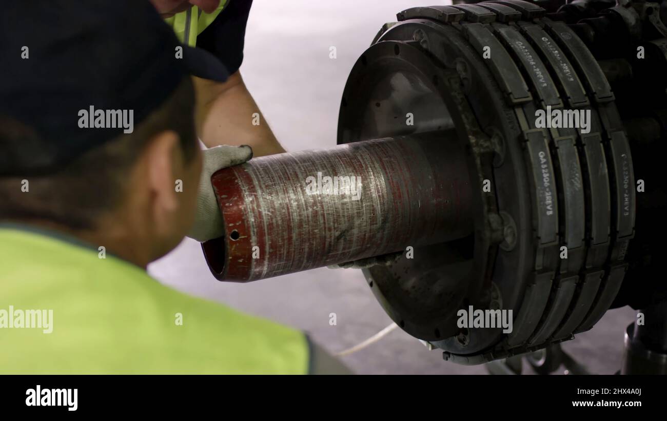 Airport worker checking chassis. Engine and chassis of the passenger ...