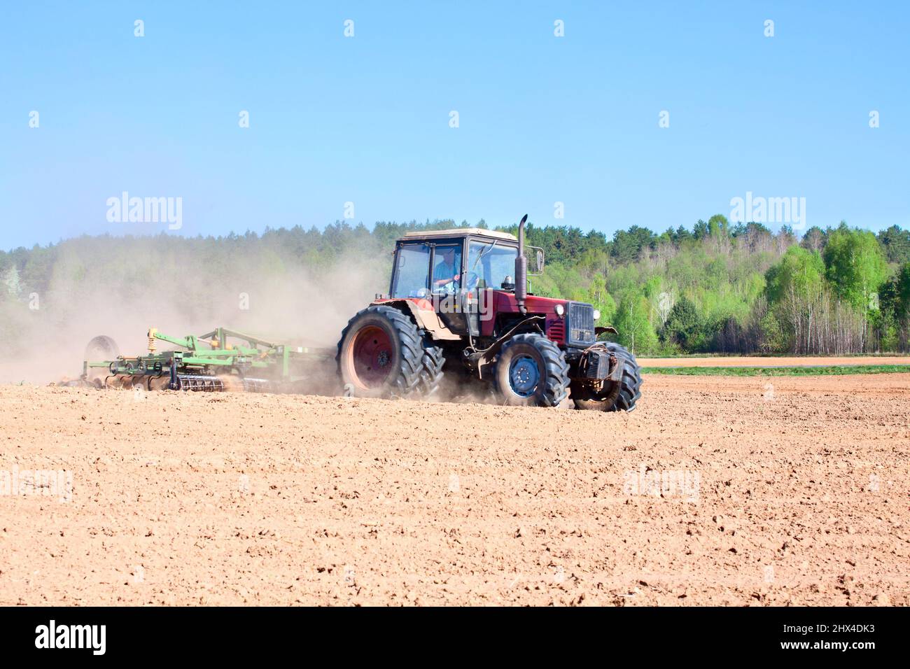 Ploughing tractor during cultivation agriculture works at field with ...