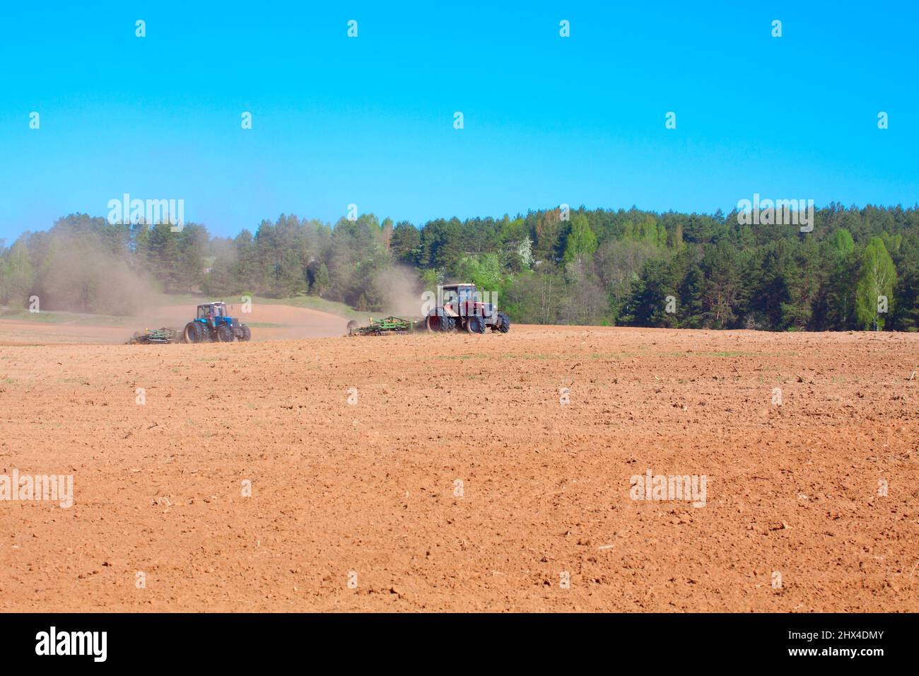 Ploughing tractor during cultivation agriculture works at field with ...