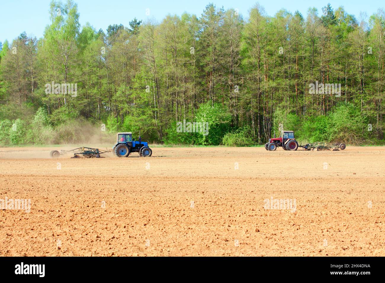 Ploughing tractor during cultivation agriculture works at field with ...