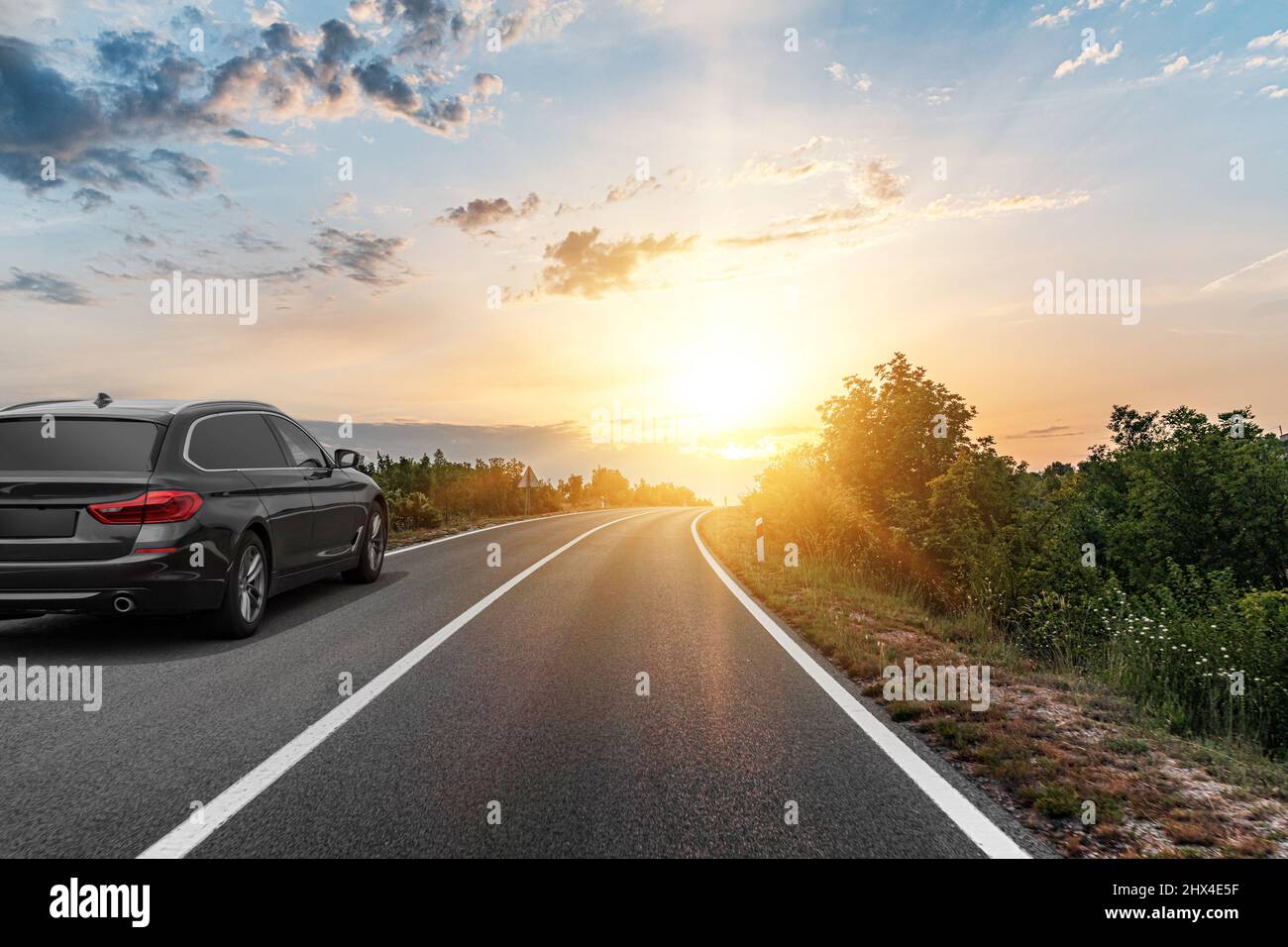 Car is driving along the road Stock Photo - Alamy