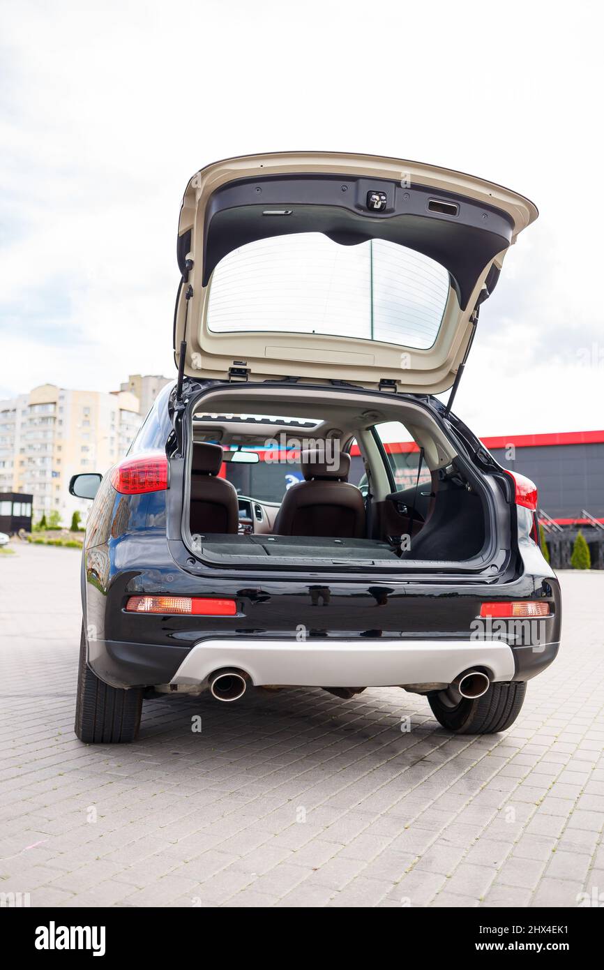 Modern black car, black SUV jeep on big wheels. Rear view of open car ...