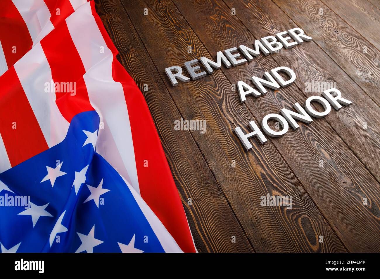 words remember and honor laid with silver metal letters on wooden ...