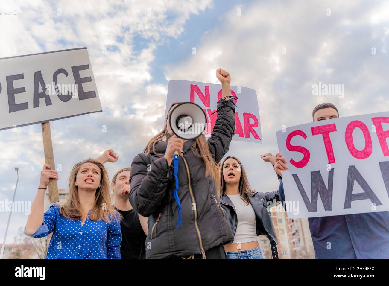Group of young people are shouting and protesting together on the ...