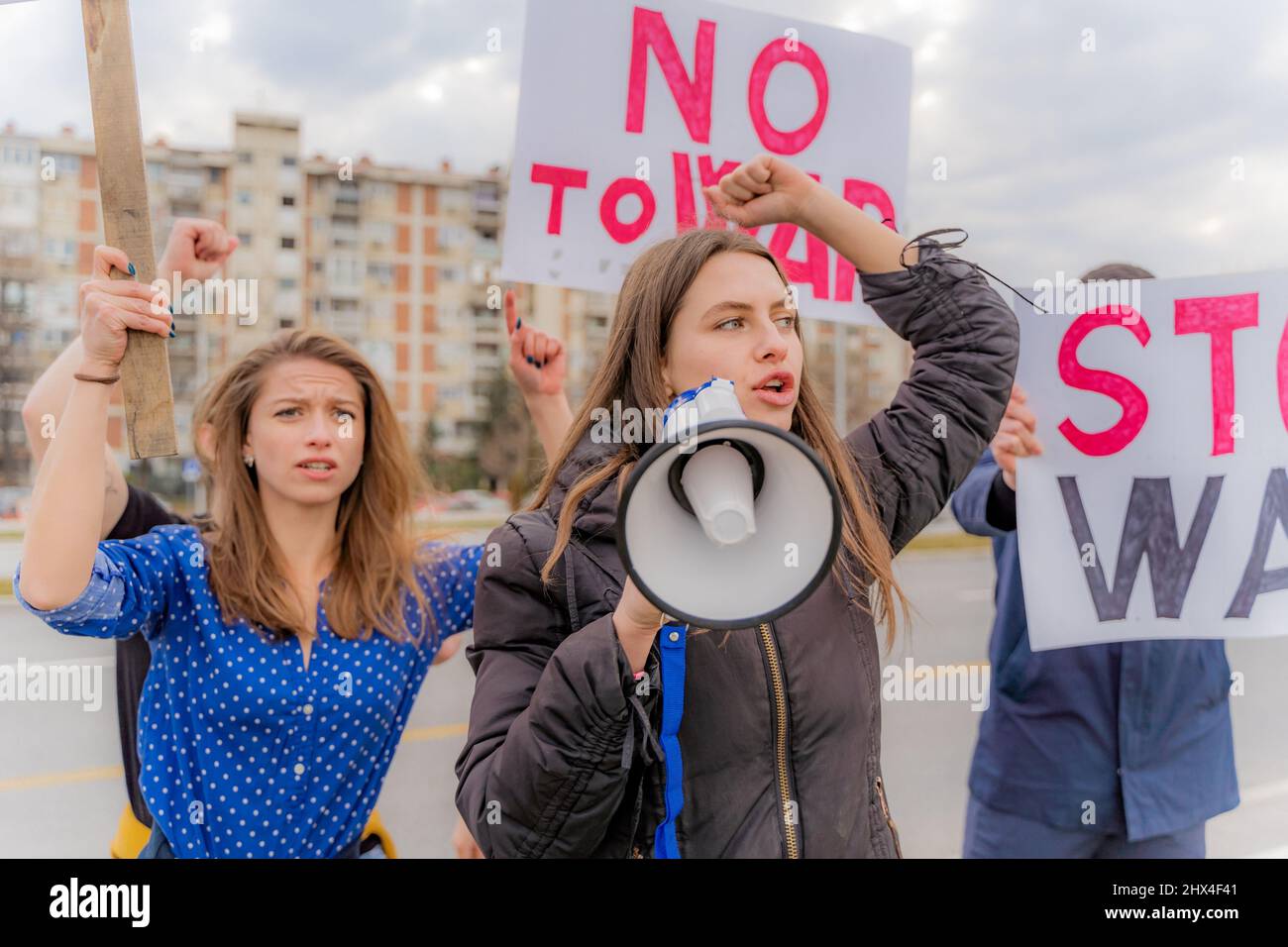 Group of young people are holding the protest signs and shouting Stock ...