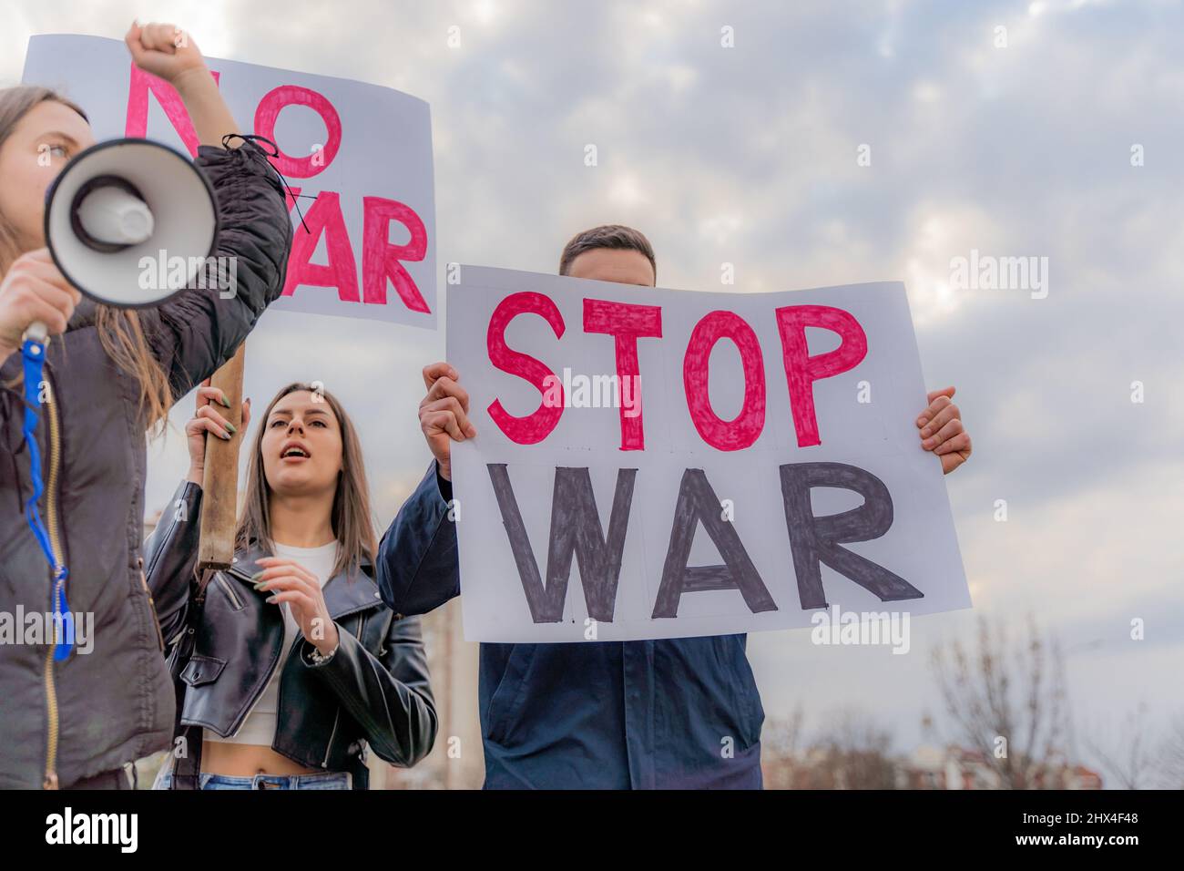 Group of young people are holding the protest signs Stock Photo - Alamy