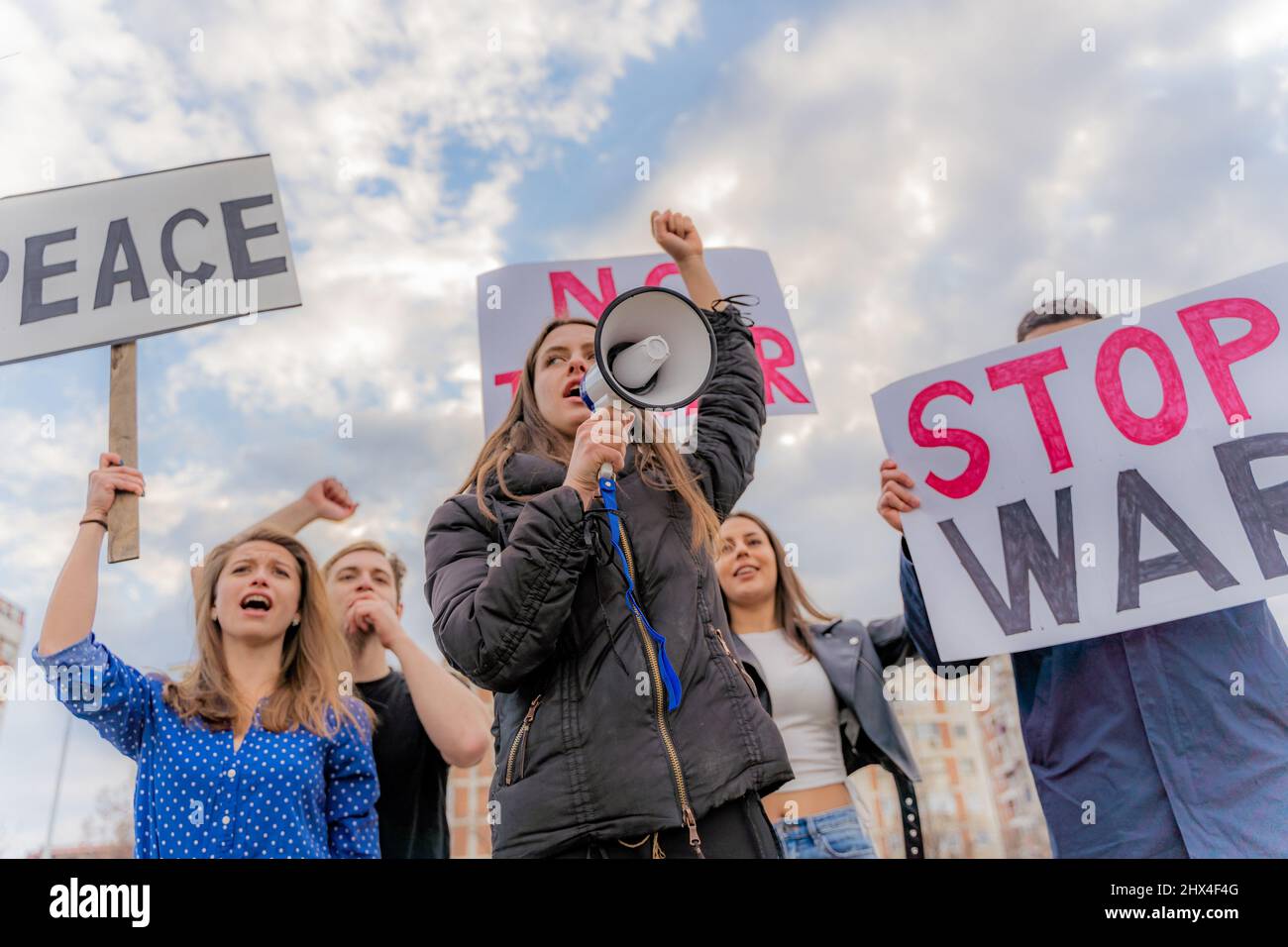 Group of young people are shouting and protesting together on the ...